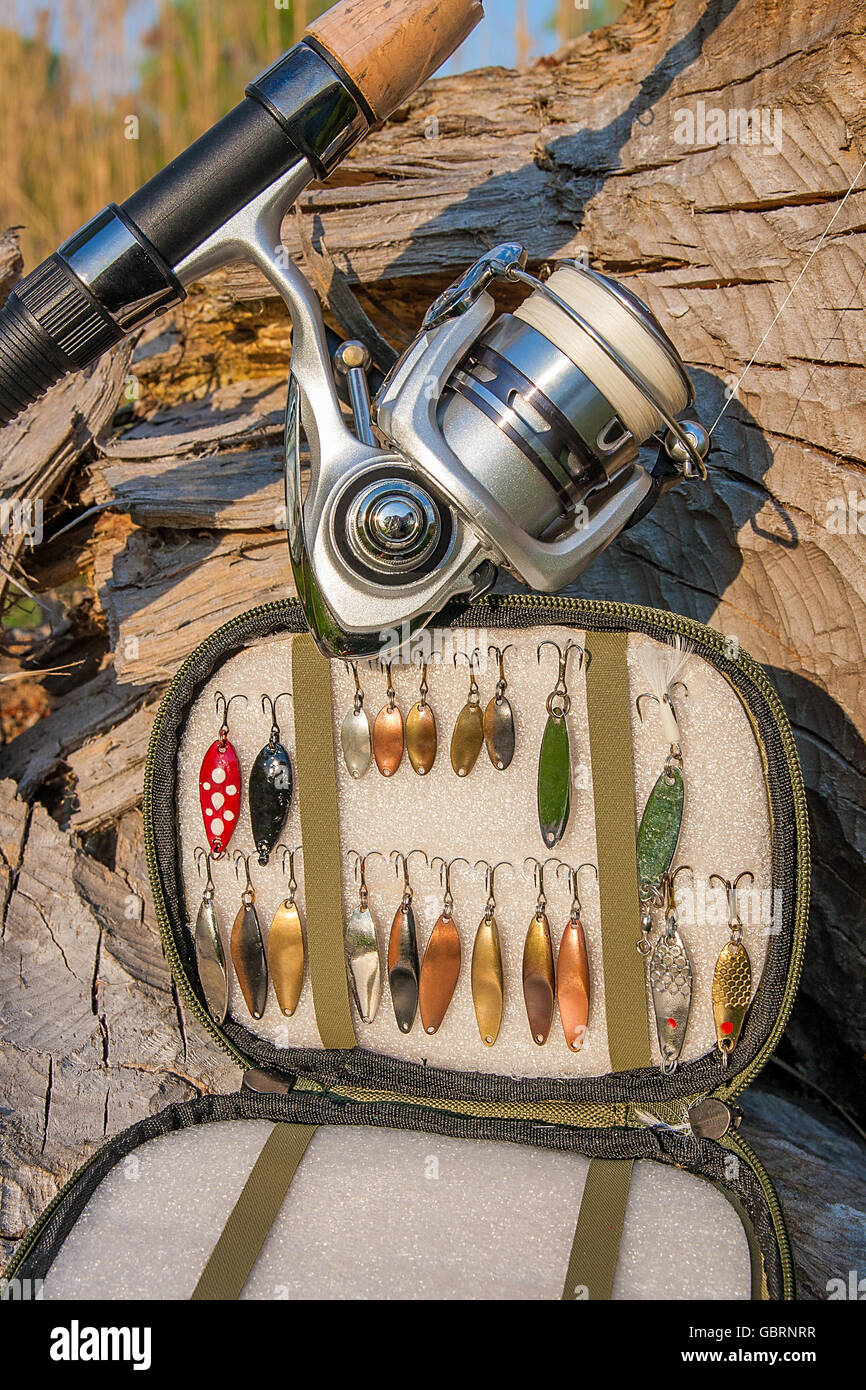Fishing rod with fishing reel on the natural background. Assorted of ...