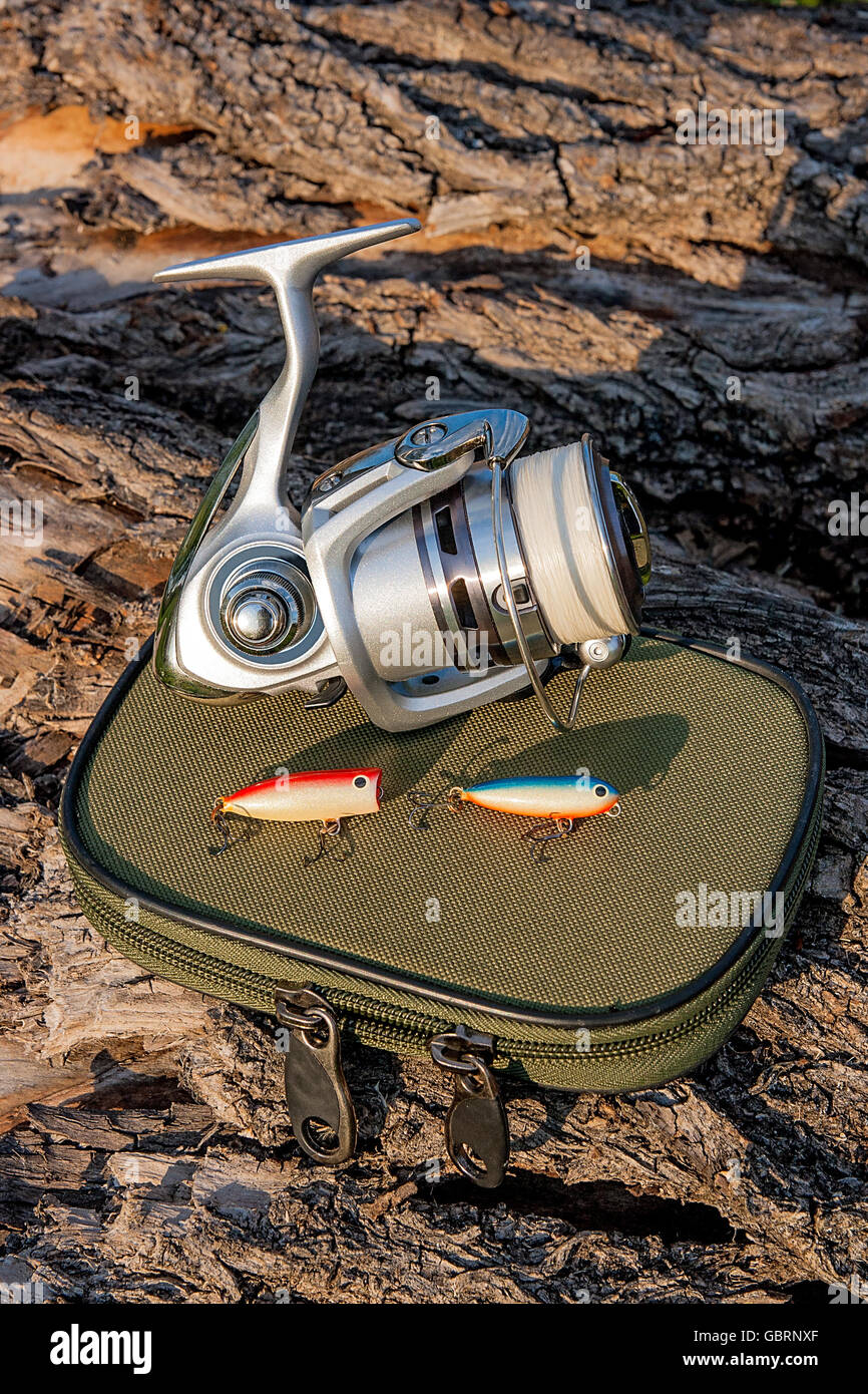 Fishing rod with fishing reel on the natural background. Assorted of ...