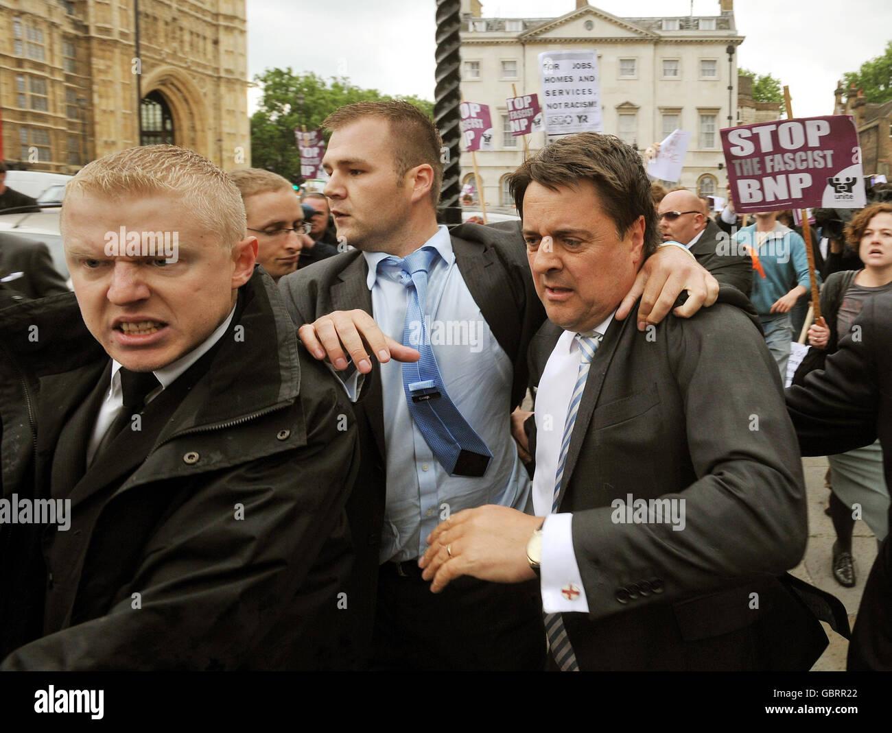 BNP leader Nick Griffin (right) runs for his car as he abandons a press ...
