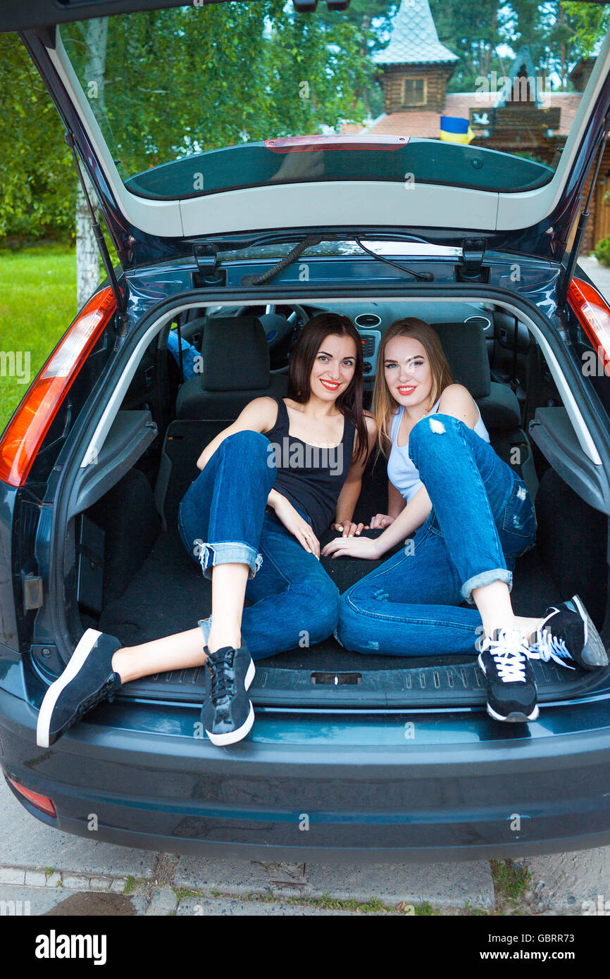 Two girls posing in car Stock Photo - Alamy