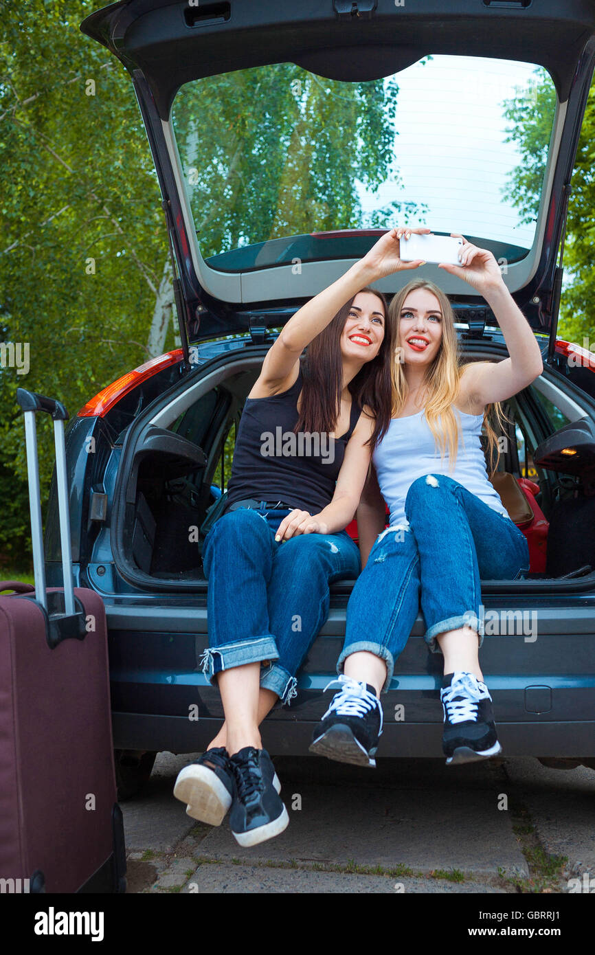 Two girls posing in car Stock Photo - Alamy