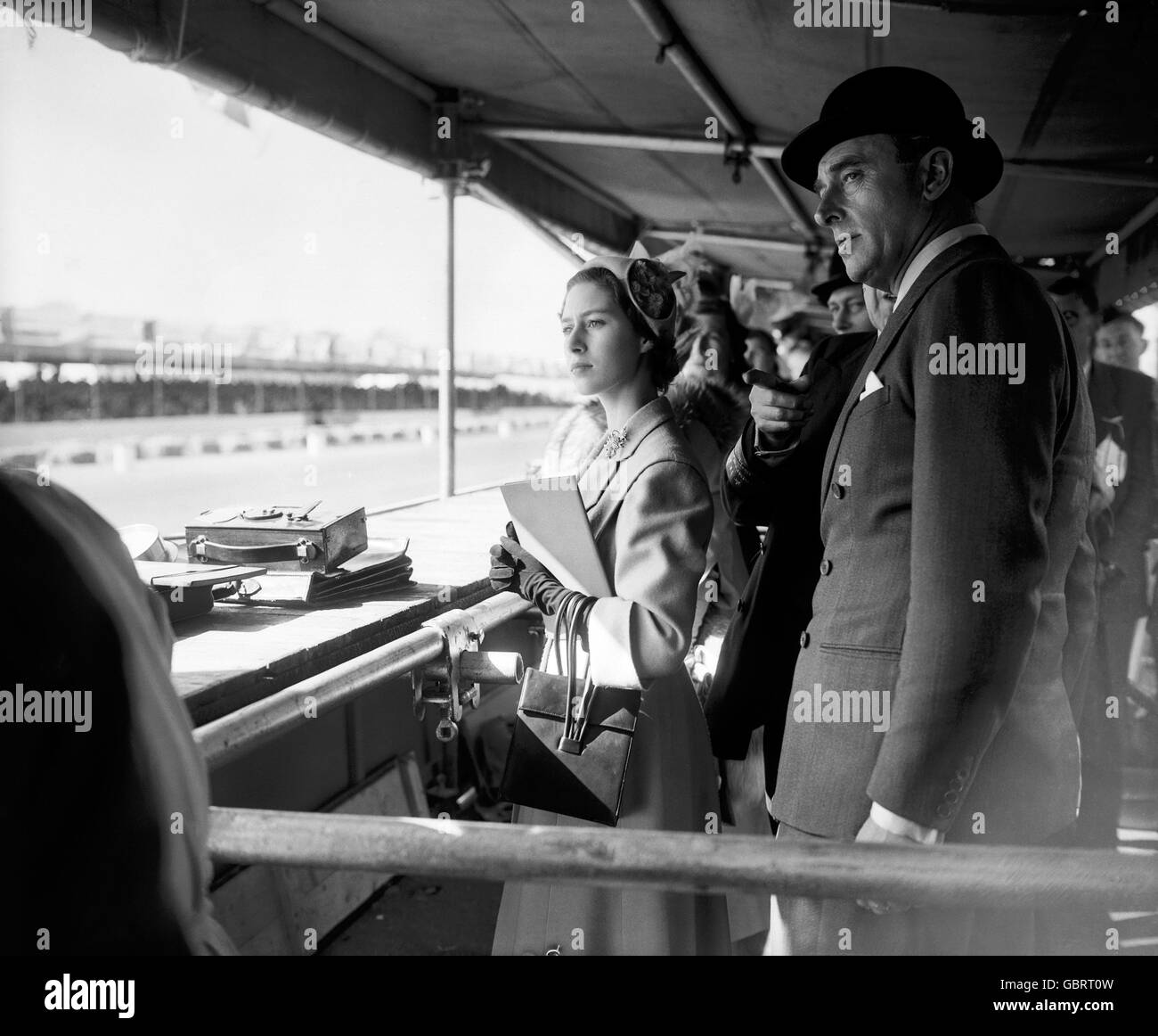 Princess Margaret and Earl Mountbatten watching the race from the pits ...