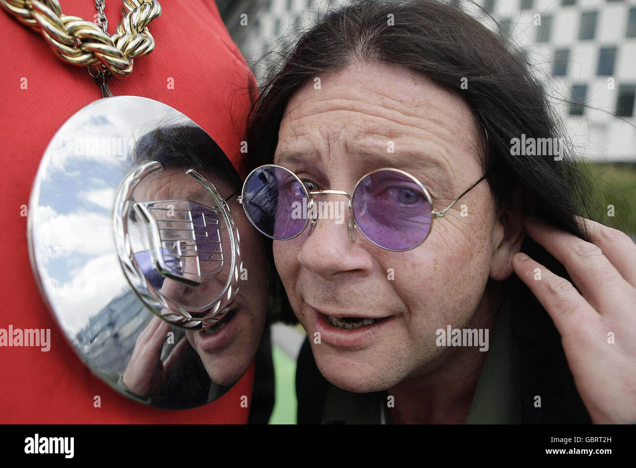 Magician Nick Nicolas fixes his hair in a break dancers medallion at ...
