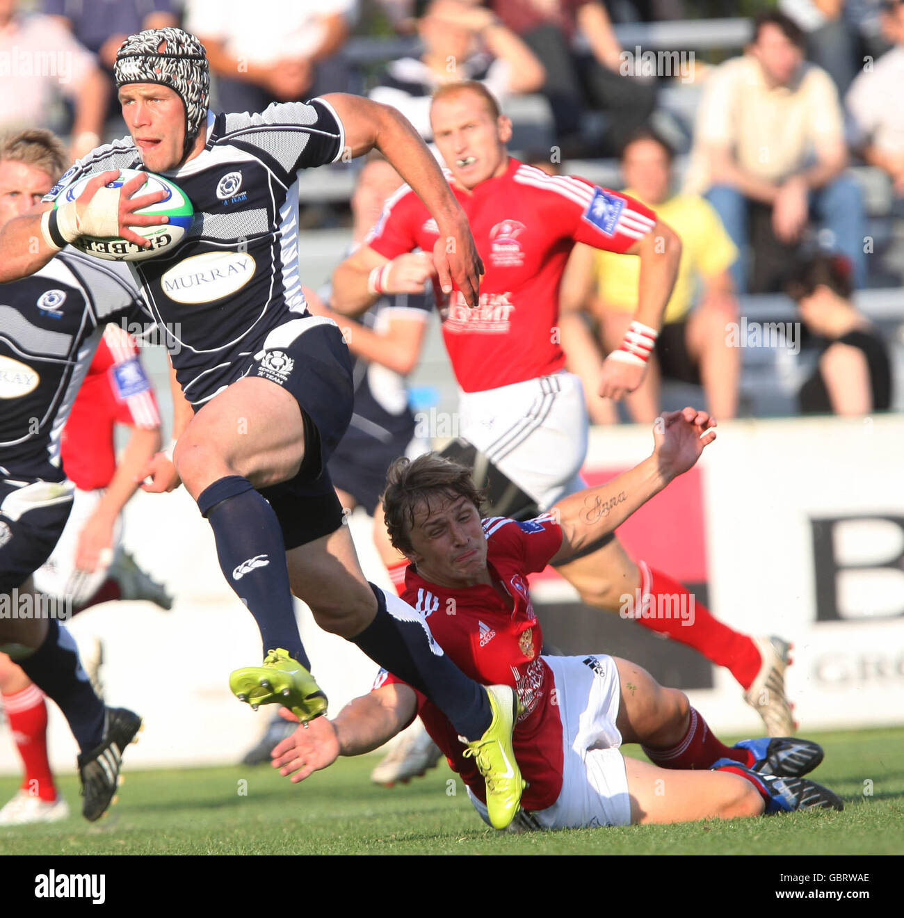 Scotland's Simon Webster (left) breaks through the Russian defence ...
