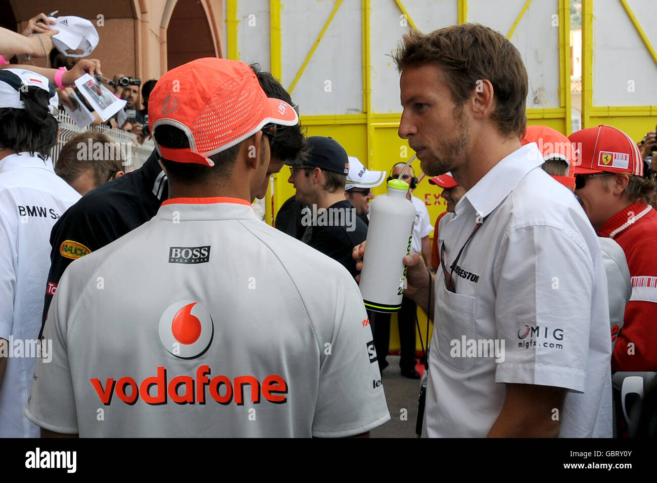 McLaren-Mercedes' Lewis Hamilton (left) talks to Brawn-Mercedes Jenson ...