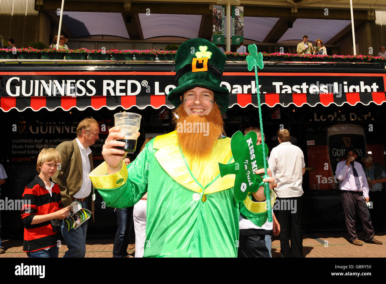 A racegoer enjoys a drink at the Guinness Bar on the Parade Ring apron ...