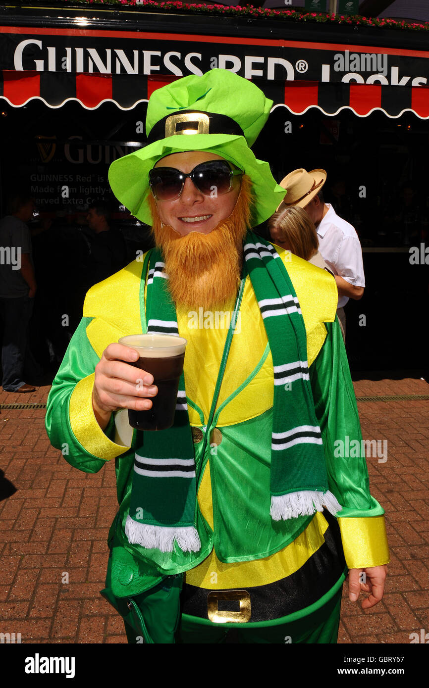 A racegoer enjoys a drink at the Guinness Bar on the Parade Ring apron ...