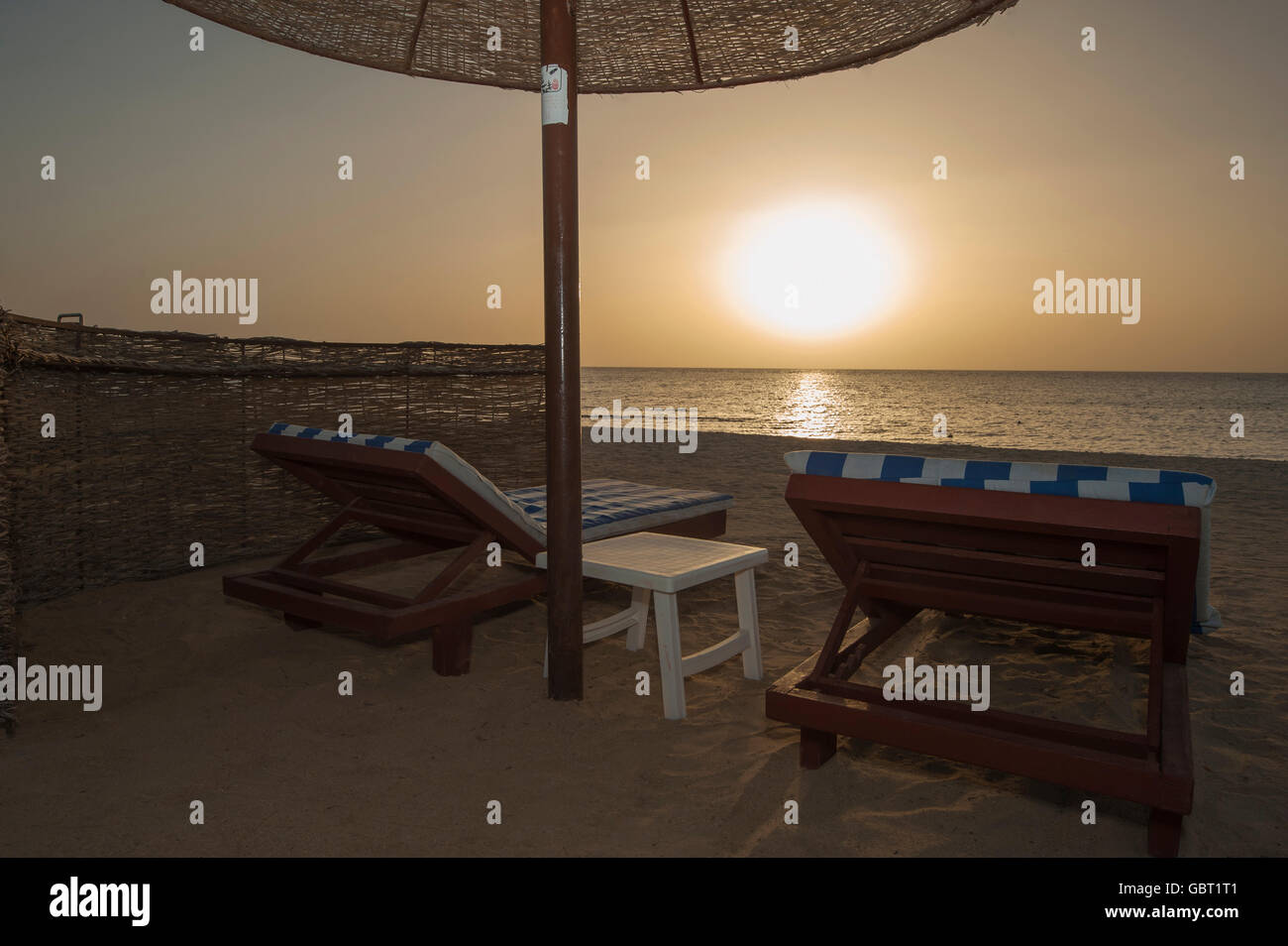 Sunrise at dawn over ocean at tropical hotel resort beach with sun ...