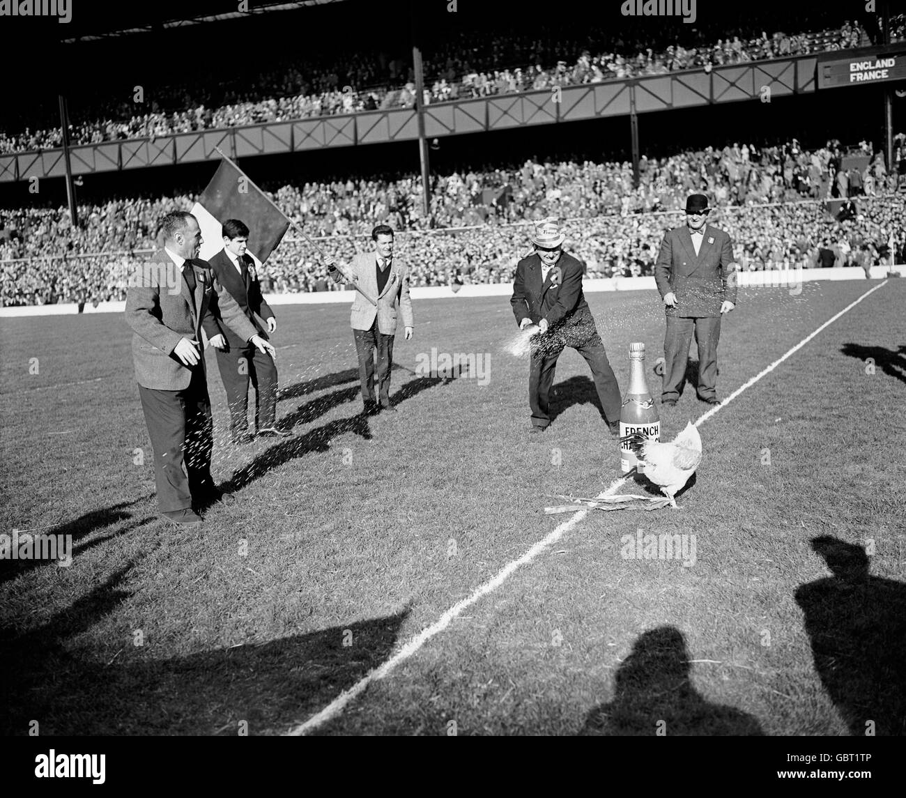 France fans spray champagne on their cockerel mascot on the Twickenham ...