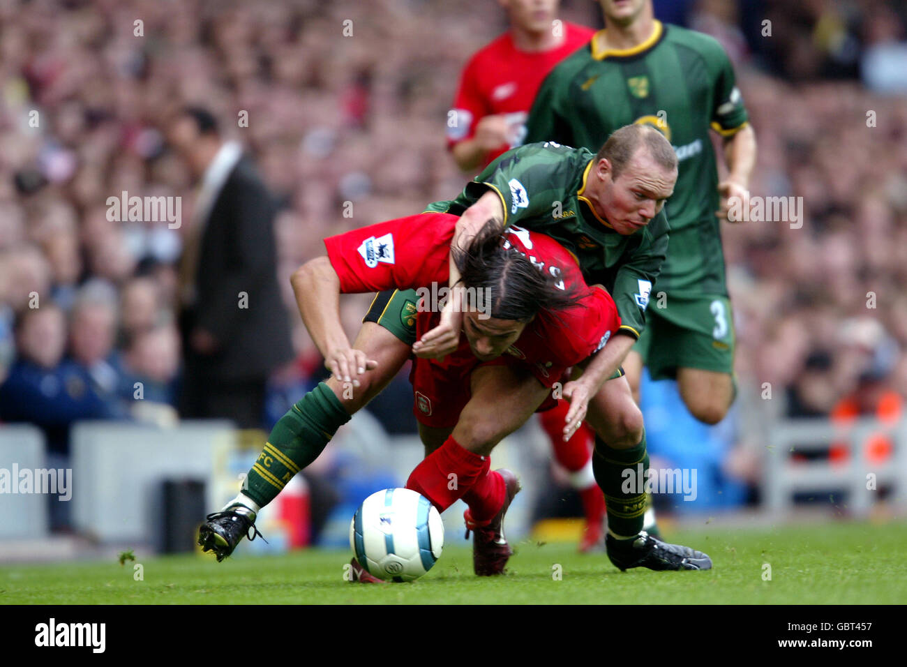 Liverpool's Milan Baros and Norwich City's Simon Charlton battle for ...