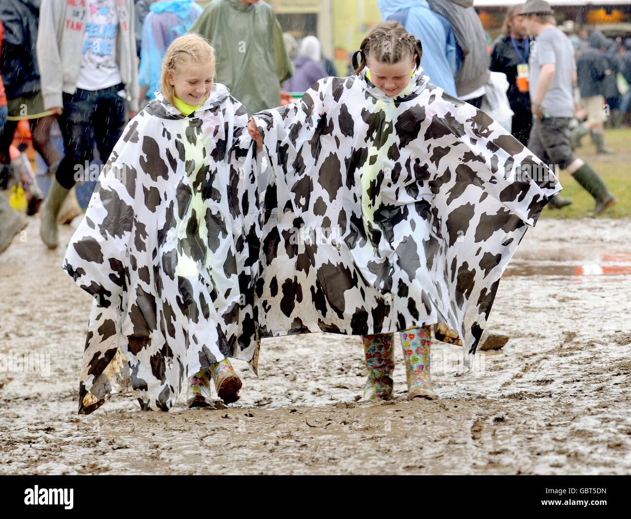 Emily Hartnell, 11, and Amy Hurd, 10, walk through mud during the 2009 ...