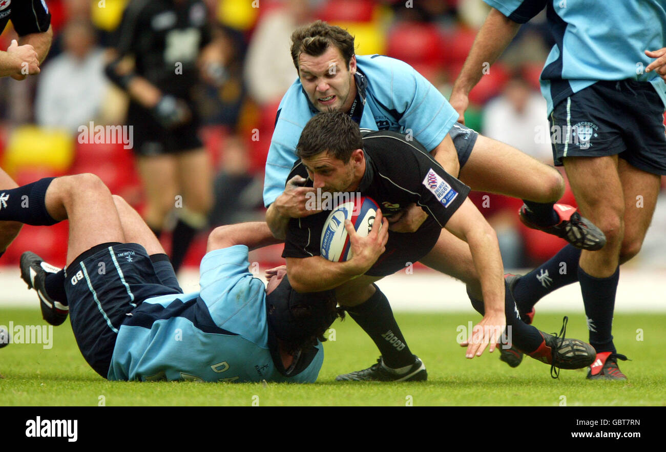 Saracens's Kevin Sorrell is tackled by Worcester's Ben Daley and Gary ...
