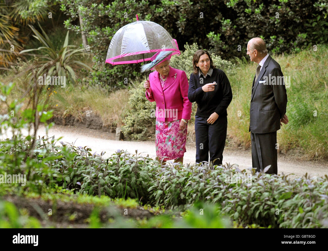 Britain's Queen Elizabeth II (left) and the Duke of Edinburgh talk to ...