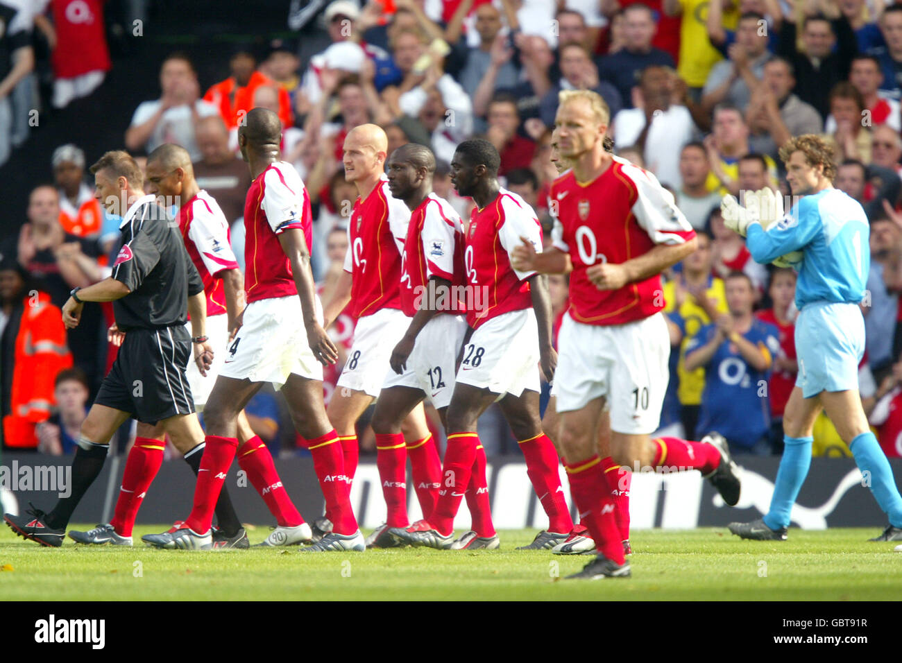 Arsenal players follow referee Mark Halsey after he disallowed a goal ...