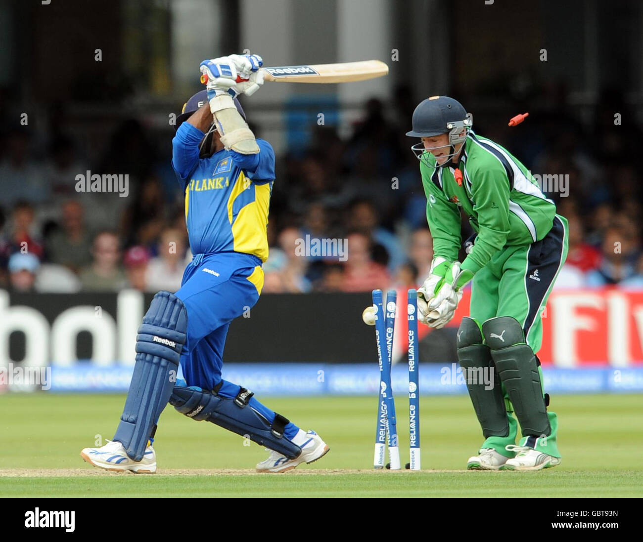 Sri Lanka's Mahela Jayawardene is bowled out by Ireland's Alex Cusack ...