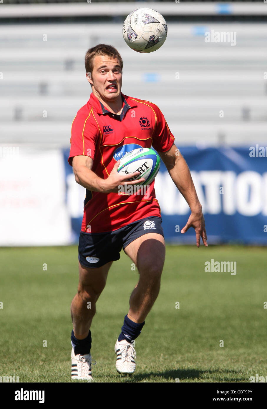 Scotland A's Alex Grove struggles to control a football whilst running ...