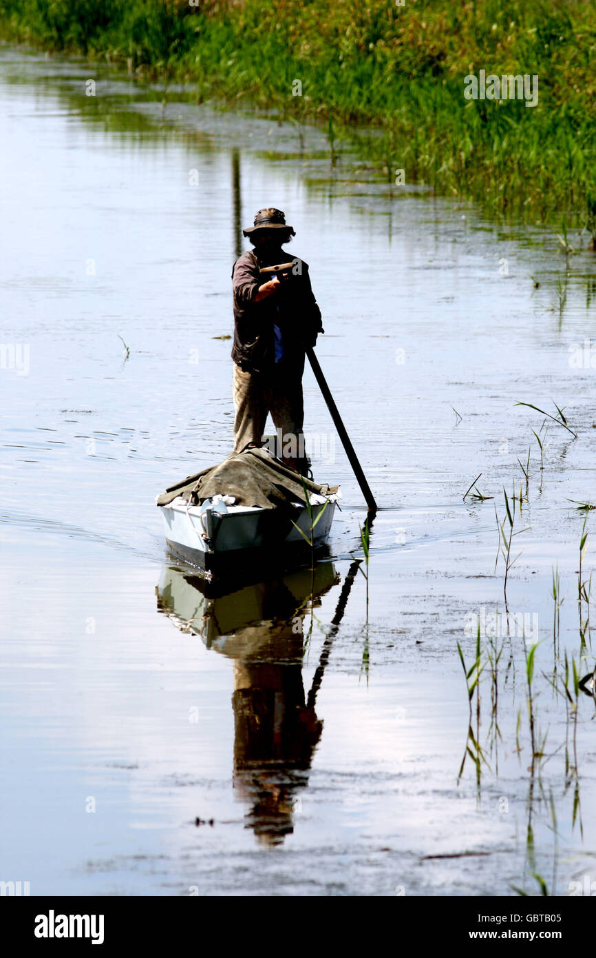 Eel catcher Peter Carter, 44, of Outwell, Norfolk, punts along the ...