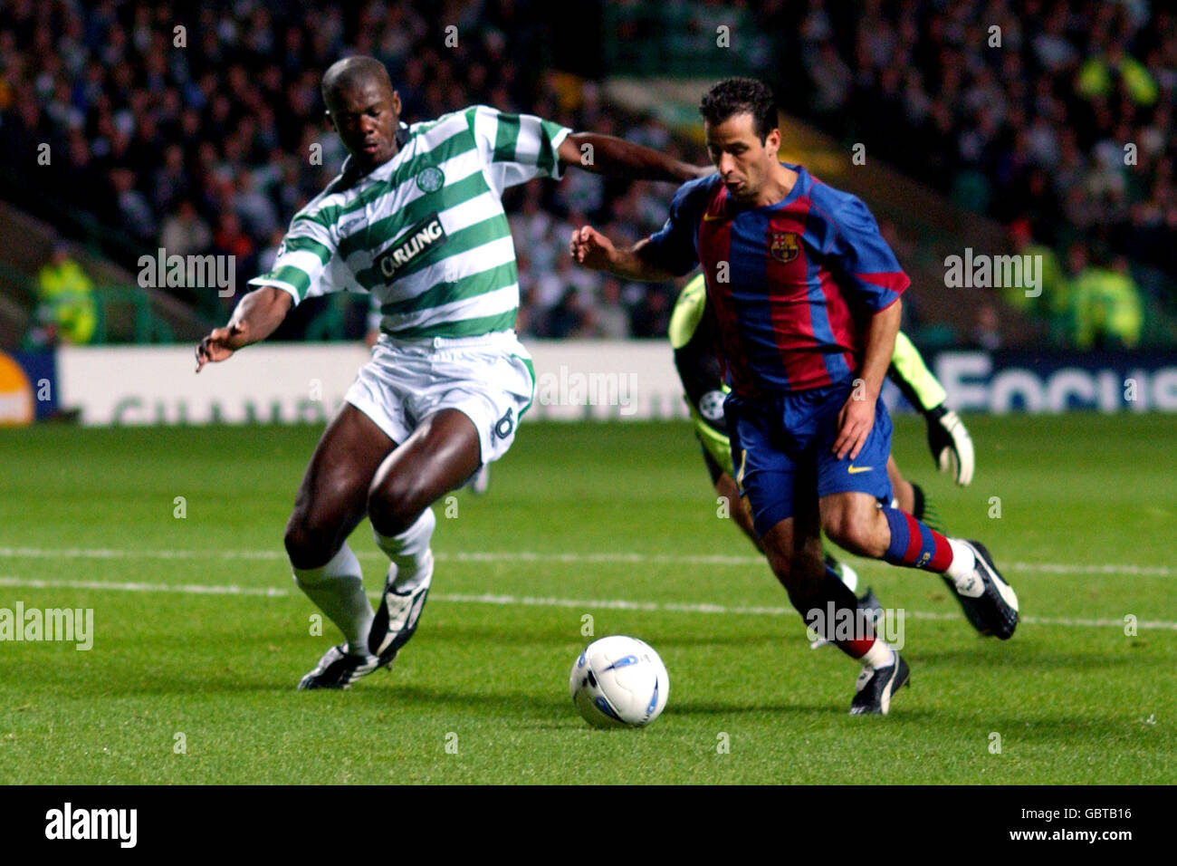 Celtic's Bobo Balde (l) attempts to break the run of Barcelona's ...