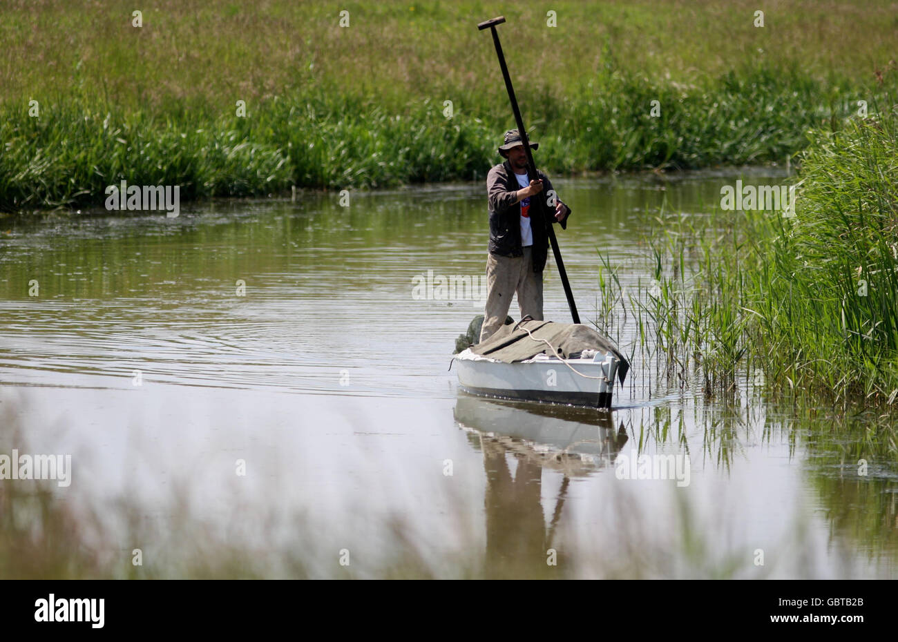 Eel catcher Peter Carter, 44, of Outwell, Norfolk, punts along the ...