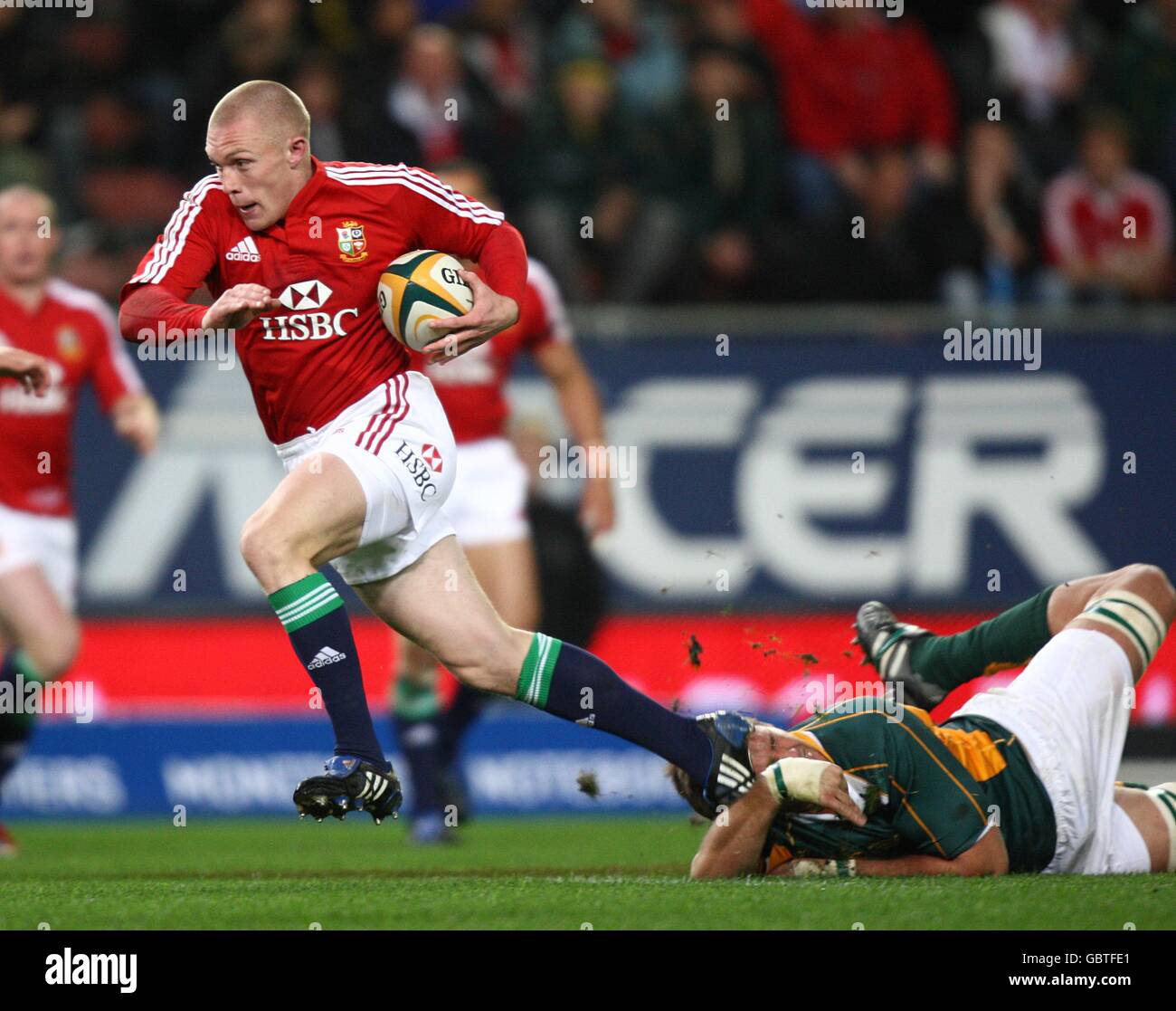 British and Irish Lions' Keith Earls gets past an attempted tackle from ...