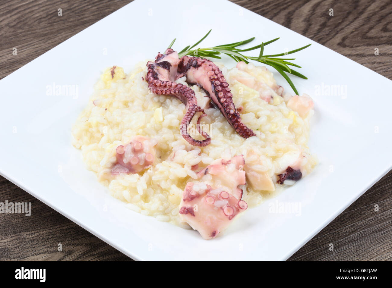 Risotto with octopus served green rosemary Stock Photo - Alamy
