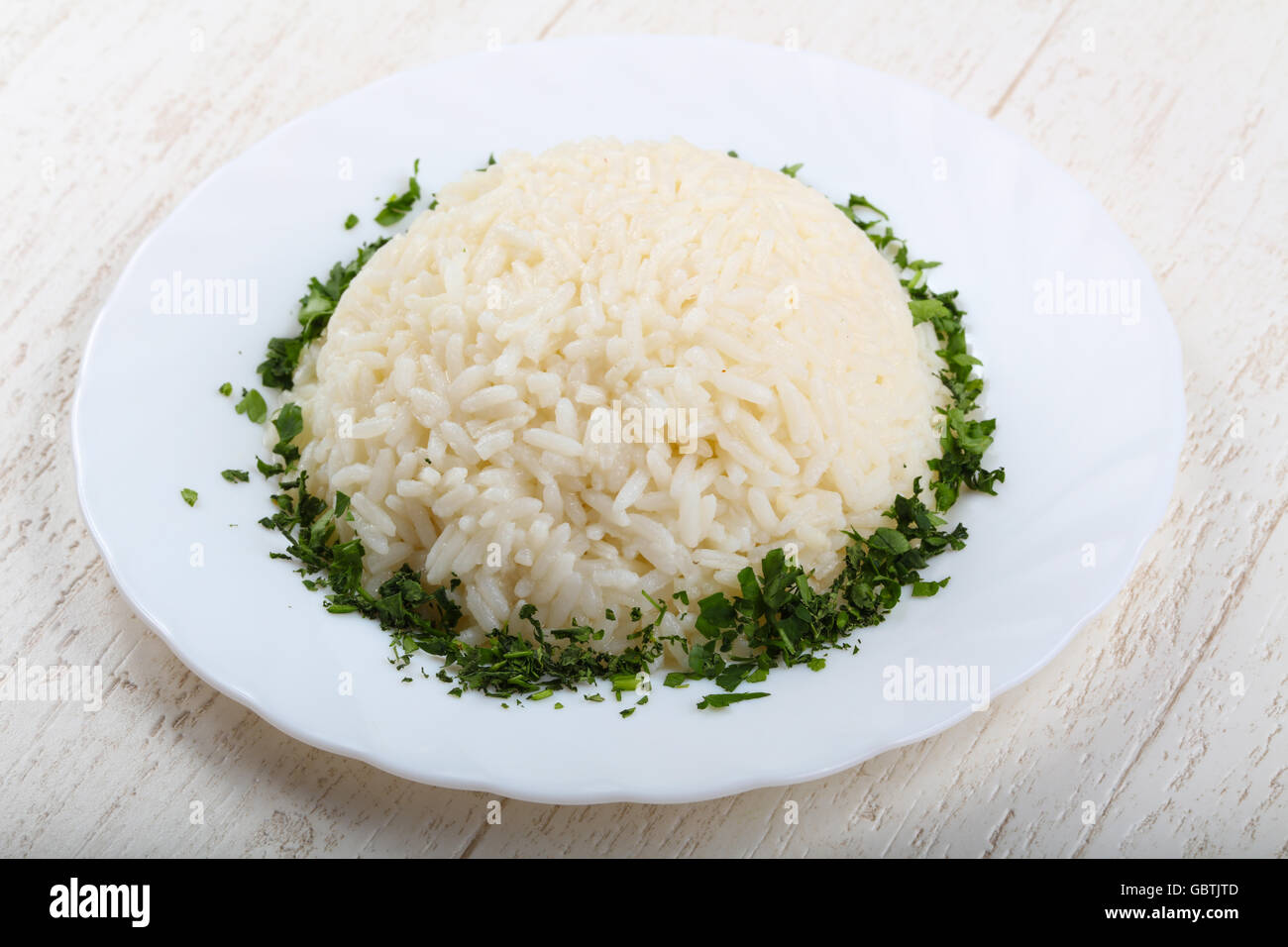 Steamed rice with parsley in the white plate Stock Photo - Alamy