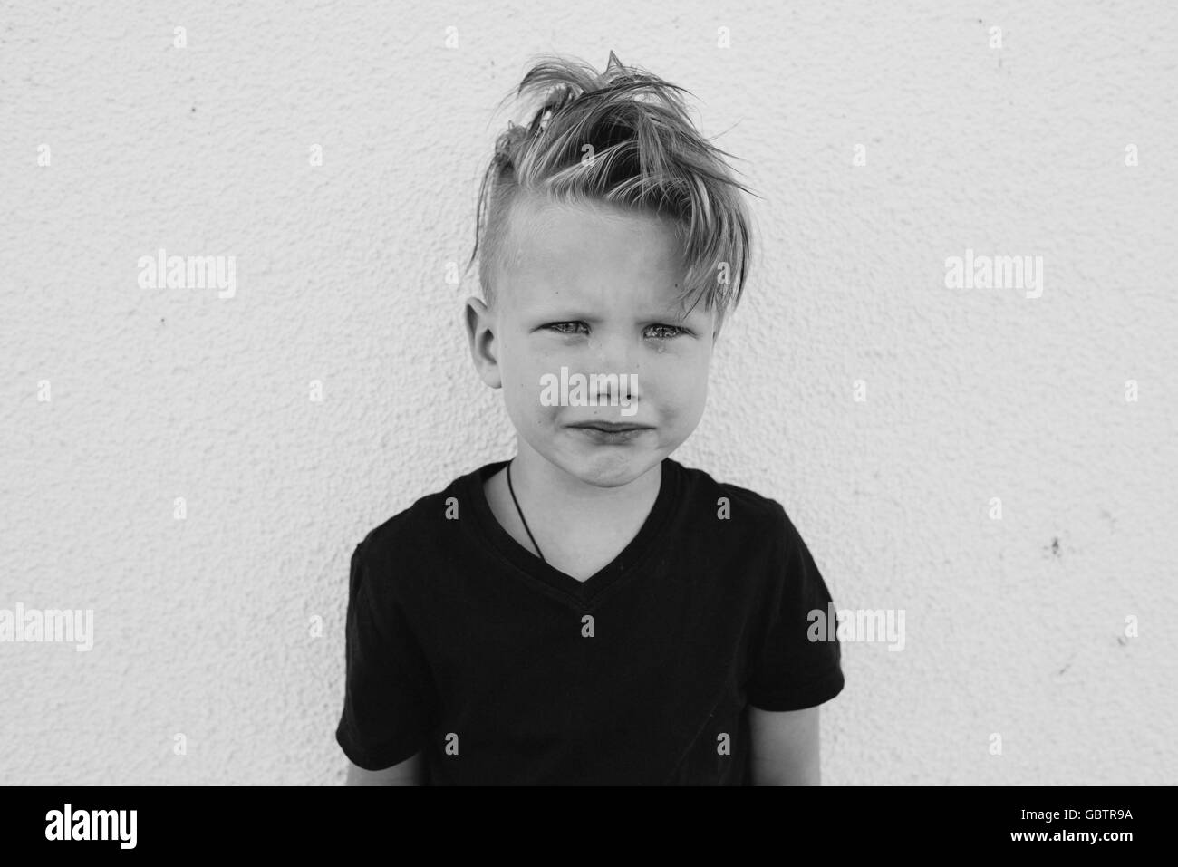 young emotional boy on bright background Stock Photo - Alamy