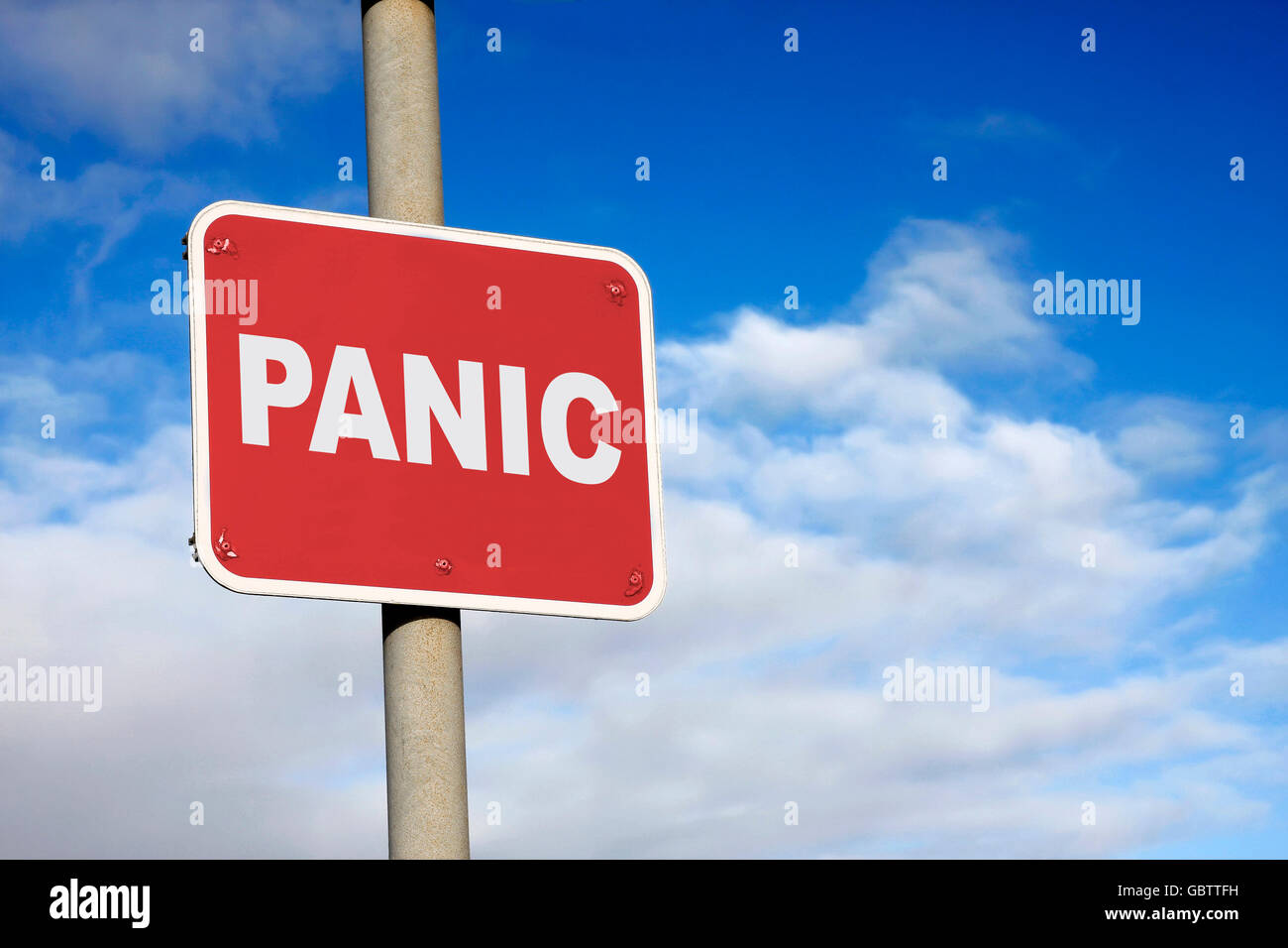 Red panic sign against a blue sky Stock Photo - Alamy