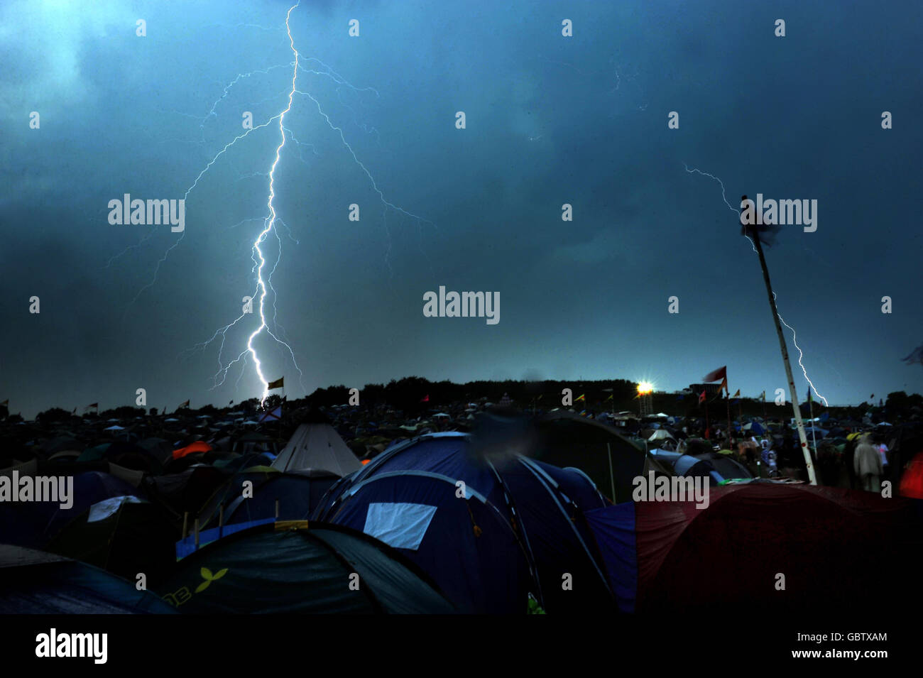 Lightning flashes above the 2009 Glastonbury Festival taking place at ...