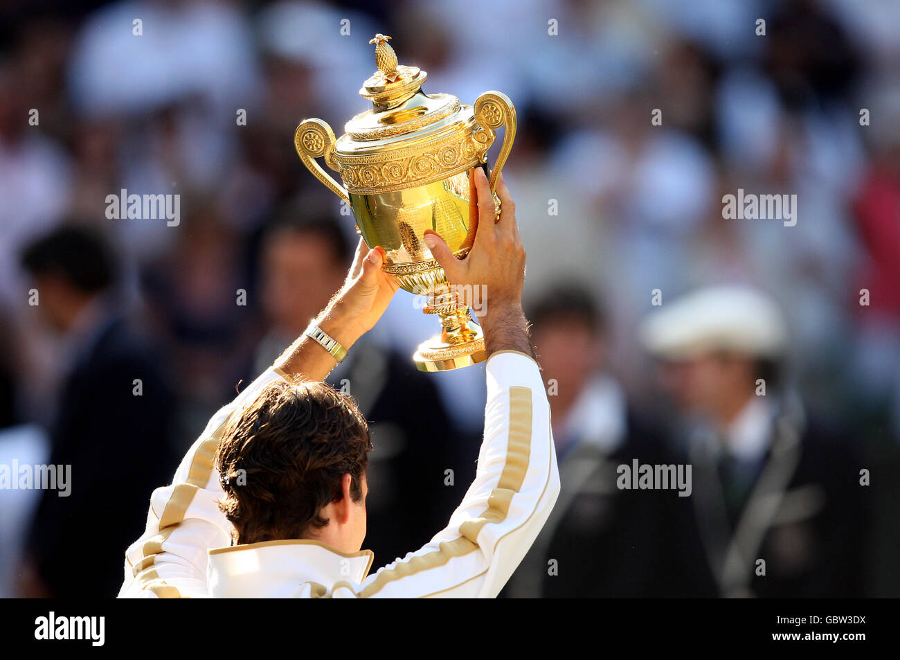 Switzerland's Roger Federer receives the trophy after beating USA's Andy Roddick to win the ...