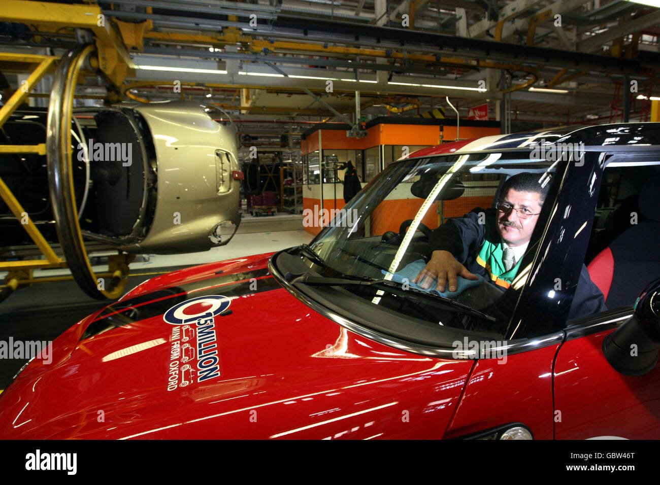 BMW Group worker Joe Prinzi cleans the 1.5 millionth car that came off ...