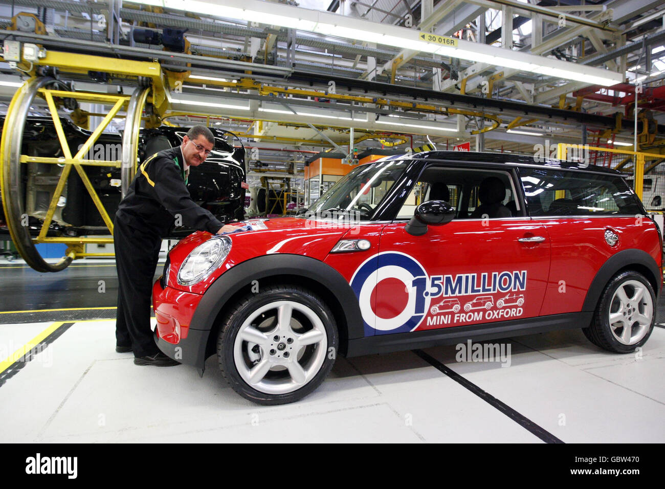 BMW Group worker Joe Prinzi cleans the 1.5 millionth car that came off ...