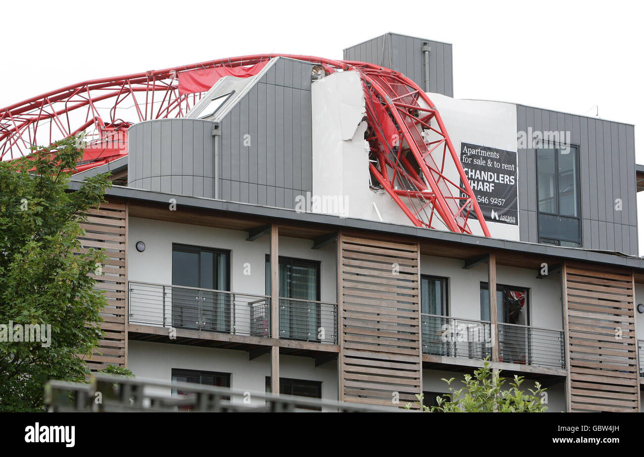 A tower crane lies across the top of residential apartments after ...