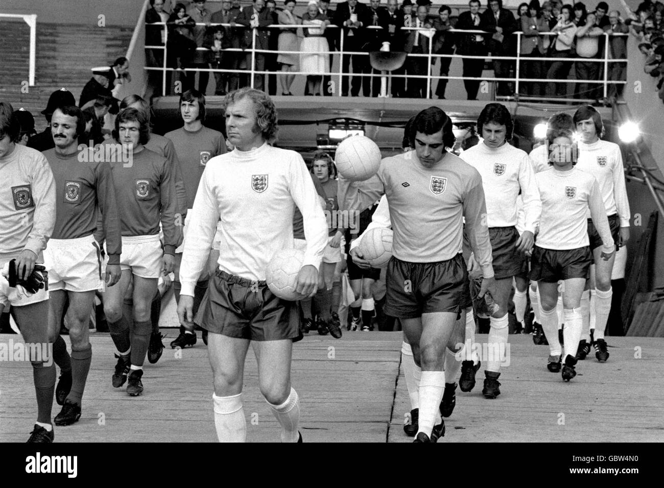 England captain Bobby Moore leads out his teammates before the match ...