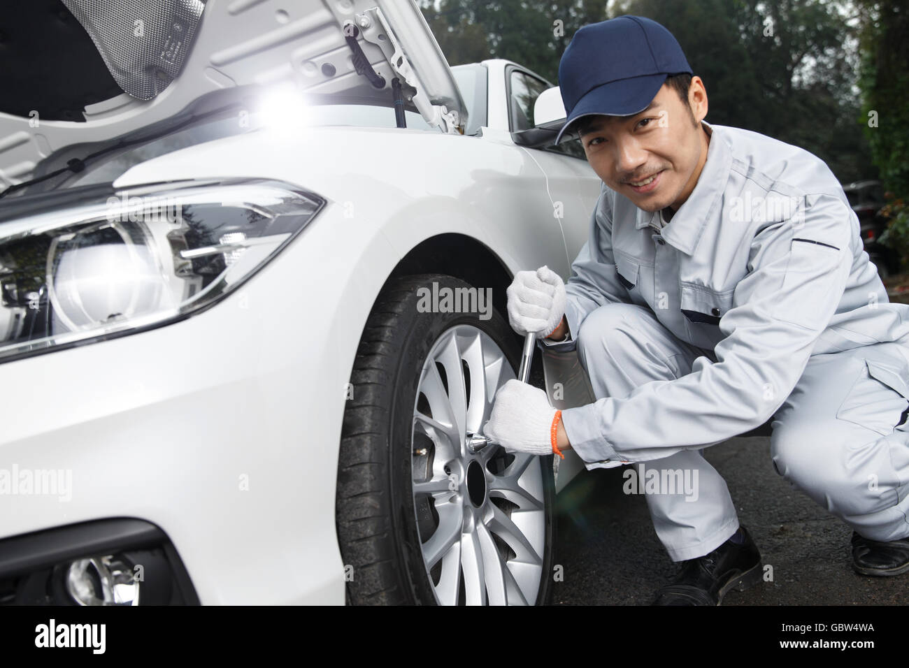 Auto repair personnel in the maintenance of automobile Stock Photo - Alamy