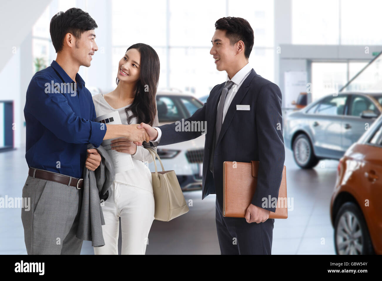 Young couple standing car dealership hi-res stock photography and ...