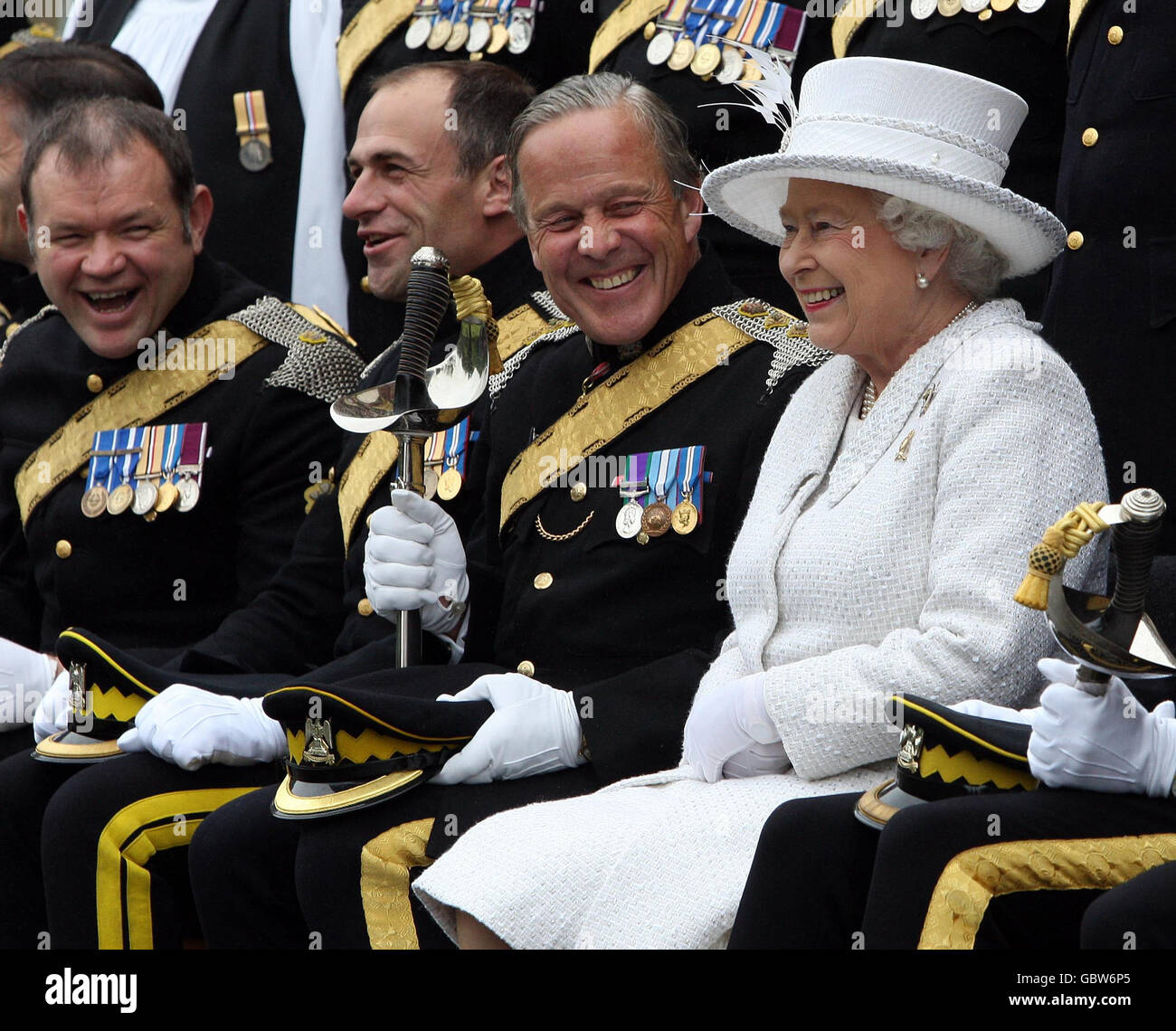 Queen Elizabeth II and Brigadier Mel Jamieson (third left) laugh as an ...