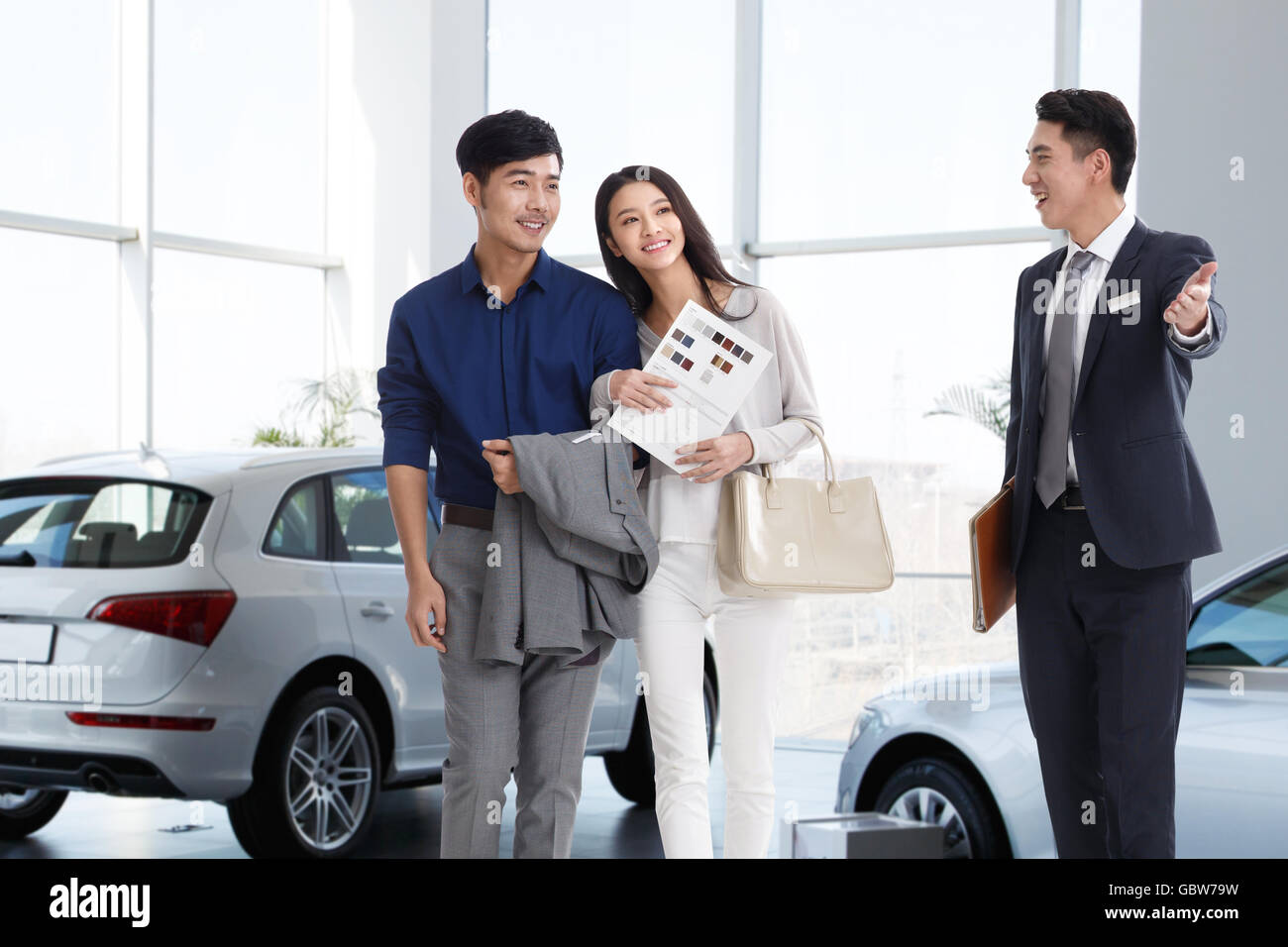 Young couple standing car dealership hi-res stock photography and ...