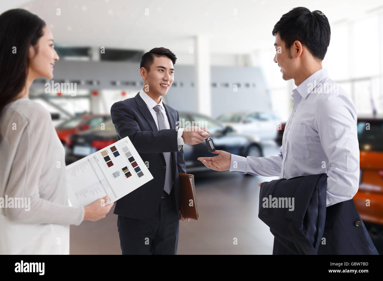 The young couple and car sales staff Stock Photo - Alamy