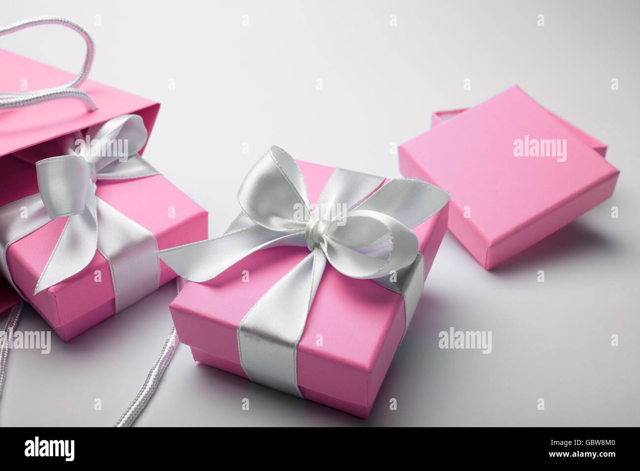 Luxury boxes tied with a white ribbon Stock Photo - Alamy