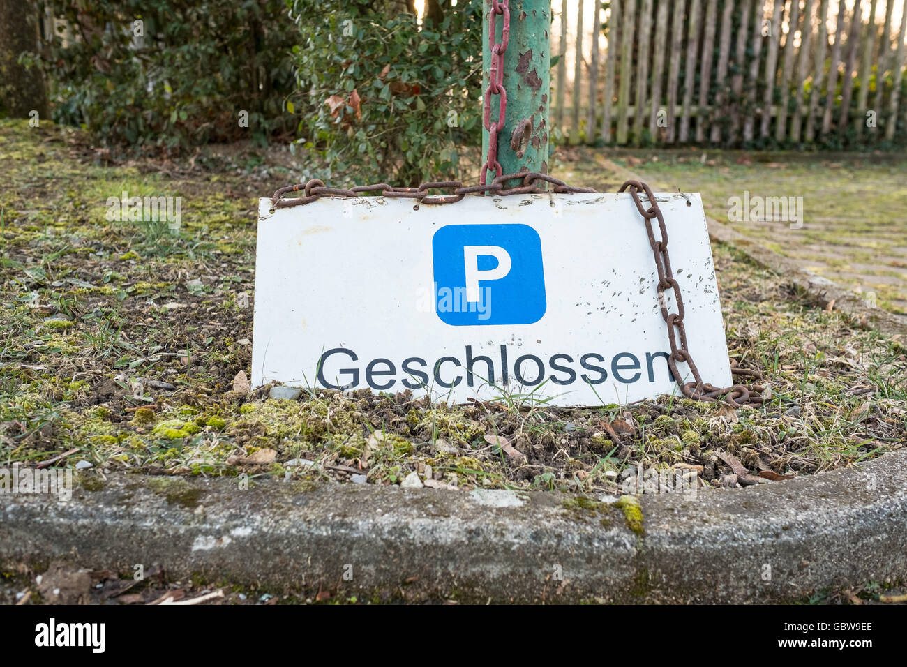 Sign parking closed with rusty chain Stock Photo - Alamy