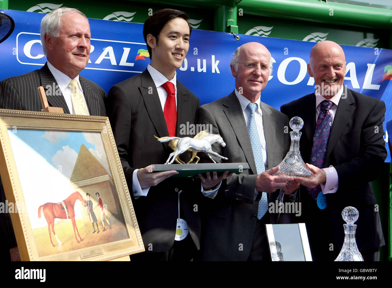 Christopher Tsui, owner of Sea The Stars (left centre) collects his trophy for winning the Coral ...
