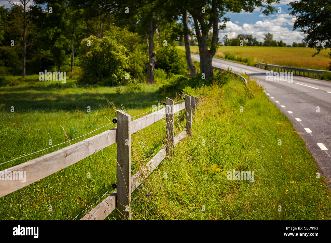 Image of wooden fence by countryside road Stock Photo - Alamy