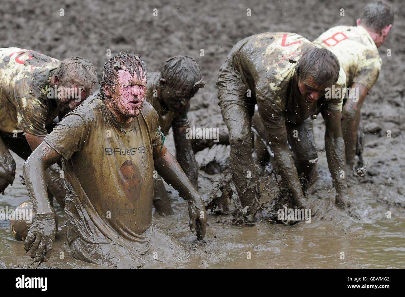 Players have fun in the mud during the Swamp Soccer New World ...