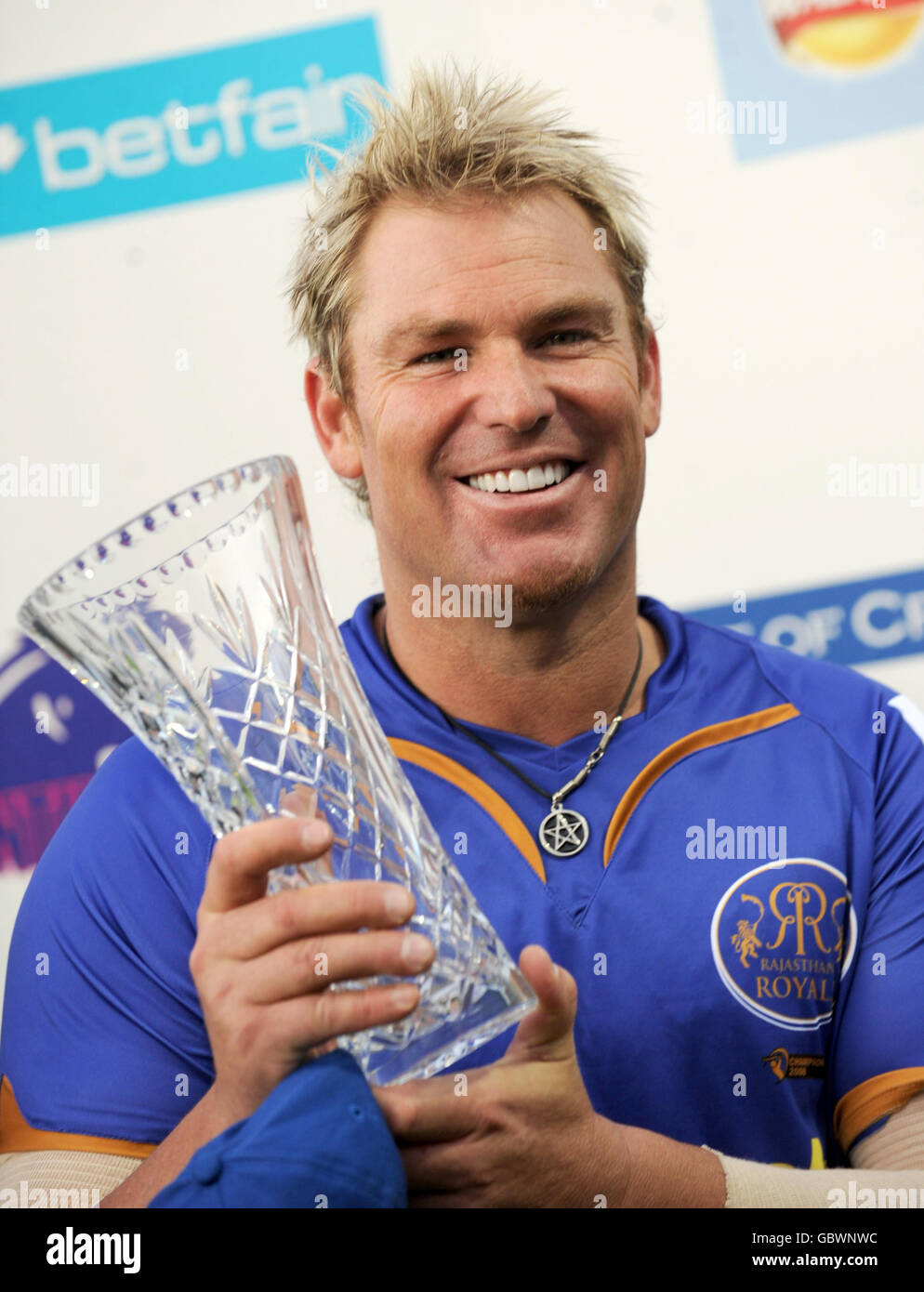 Rajasthan Royals captain Shane Warne poses with the trophy following ...