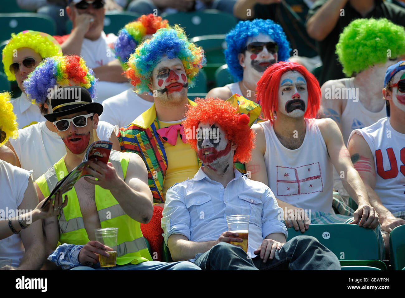 Fans dressed as clowns watch the action from the stands Stock Photo - Alamy