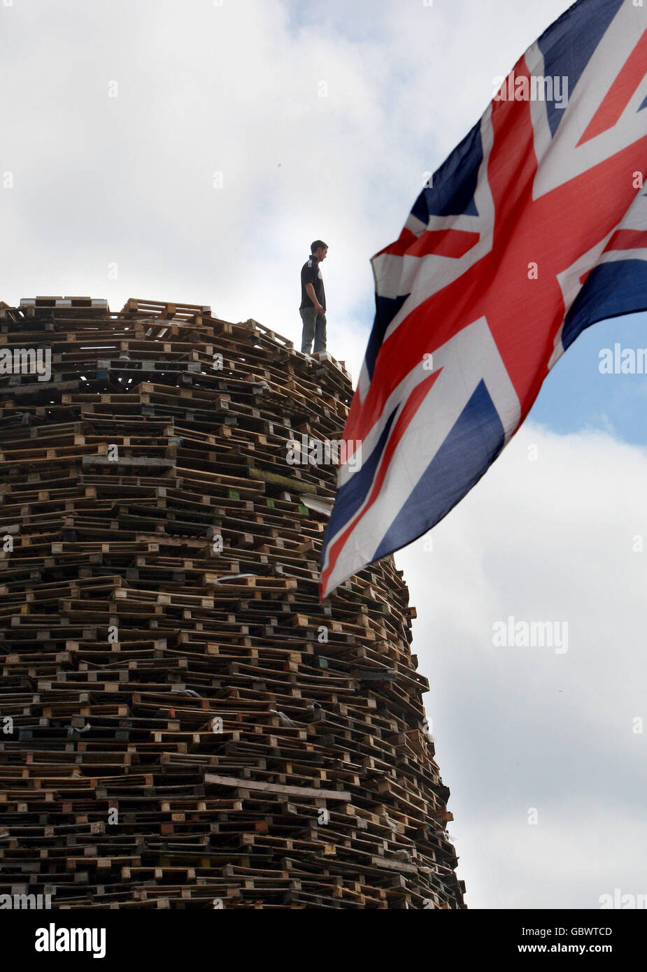 STANDALONE PHOTO A man stands on top of a bonfire in Newtownabbey ...