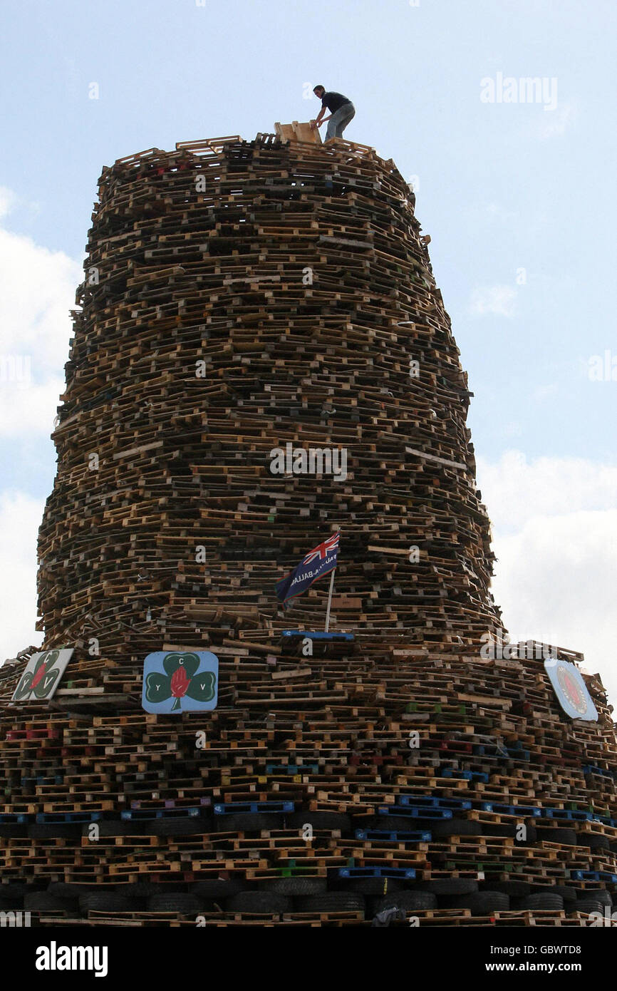 A man stands on top of a bonfire in Newtownabbey, outside Belfast ...