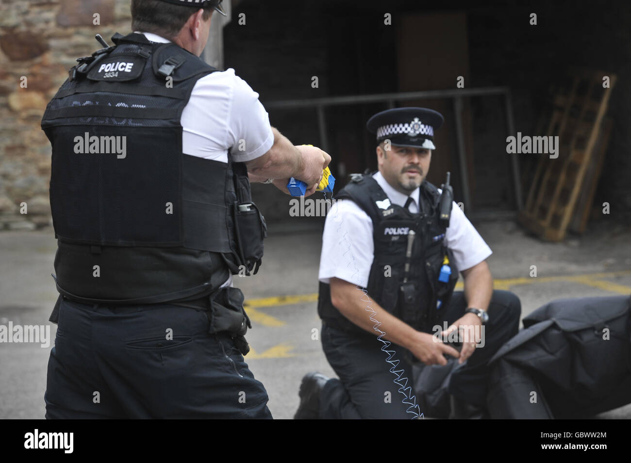Police officers train using their Taser X26 fitted with blue training ...