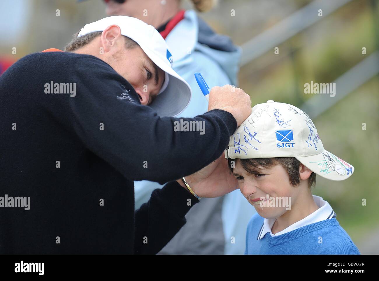 Scotland's Lloyd Saltman (left) signs an autograph for a fan during ...